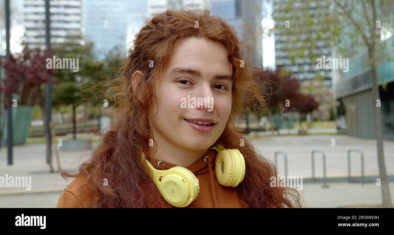 Portrait of non-binary teenager looking at camera smiling. Millennials ...