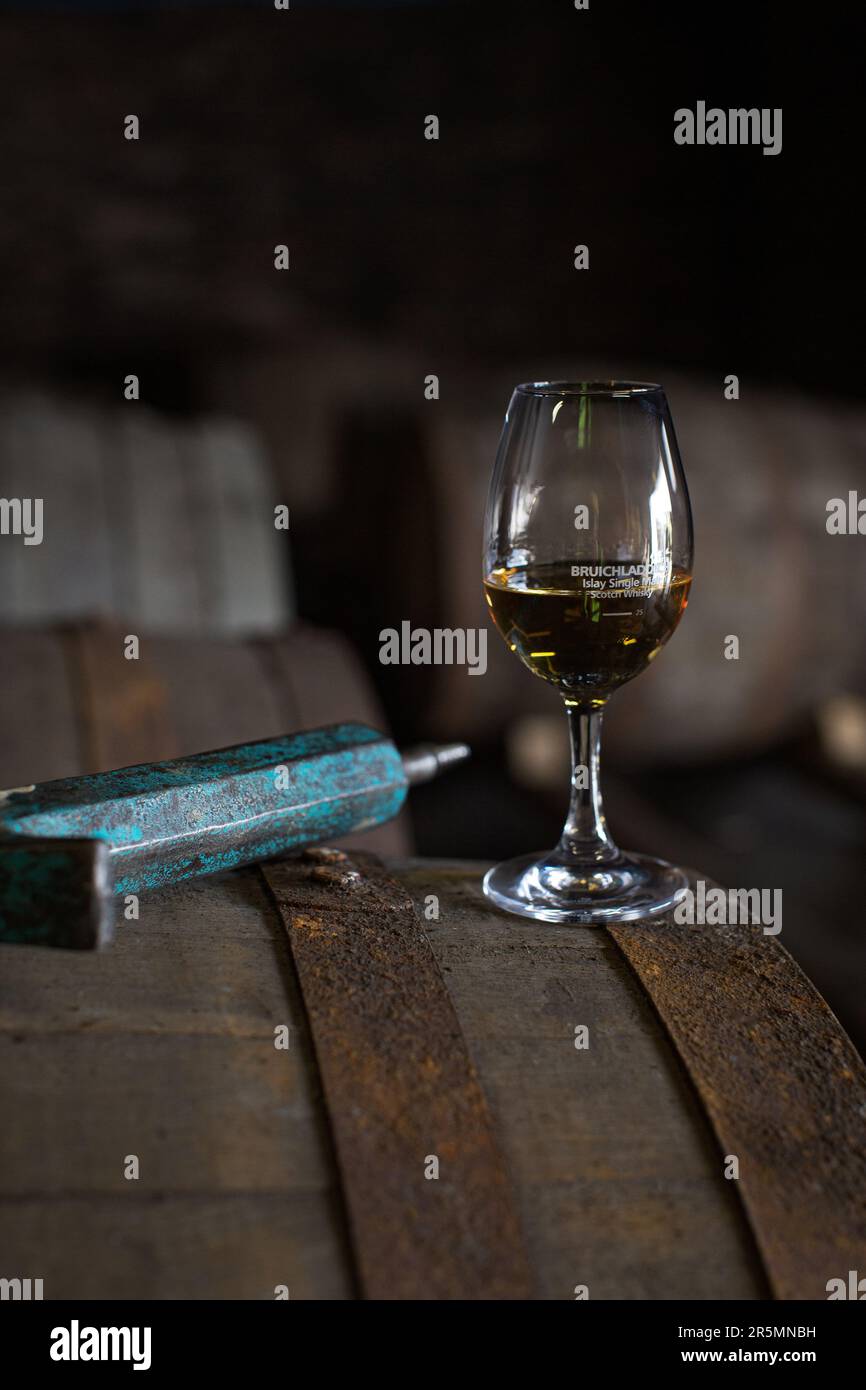 Whisky barrels ready to sample with barrel bung puller at the ...