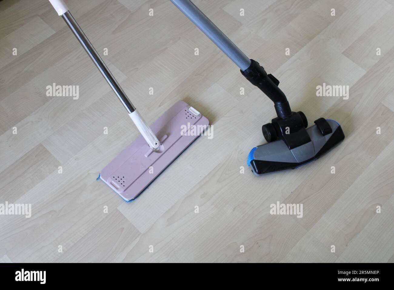 Cleaning material and vacuum cleaner on wooden floor. home cleaning ...