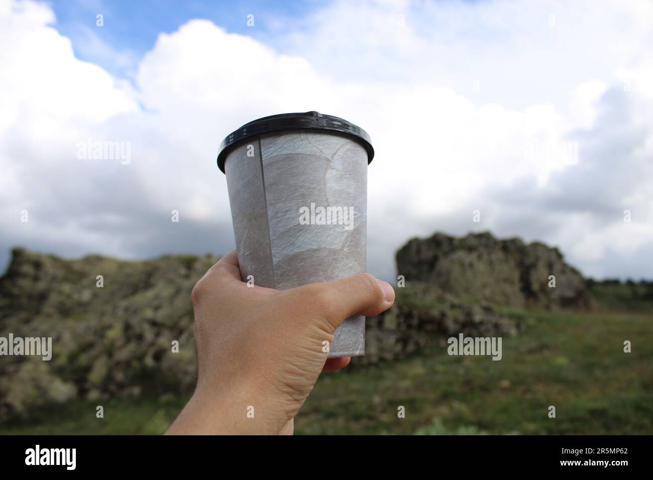 cup of coffee or tea in man's hand. consuming liquids in nature Stock ...