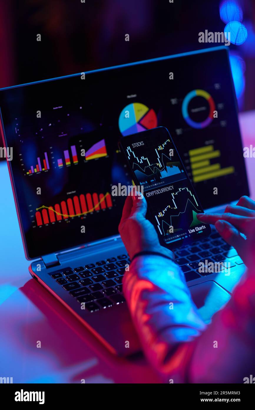 Seen from behind modern business woman with laptop and smartphone ...