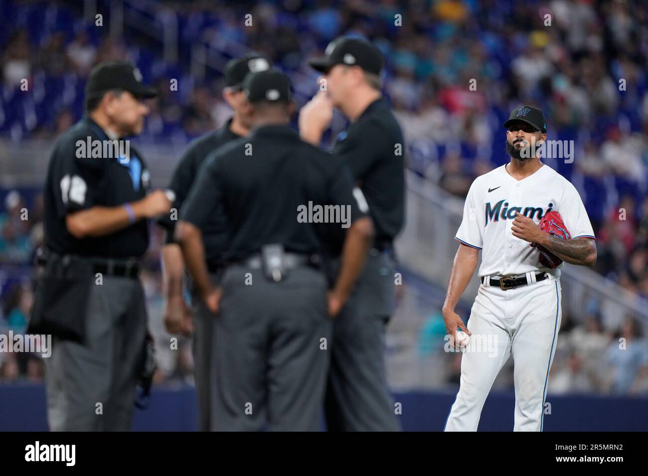 Miami Marlins starting pitcher Sandy Alcantara, right rear, looks on as ...
