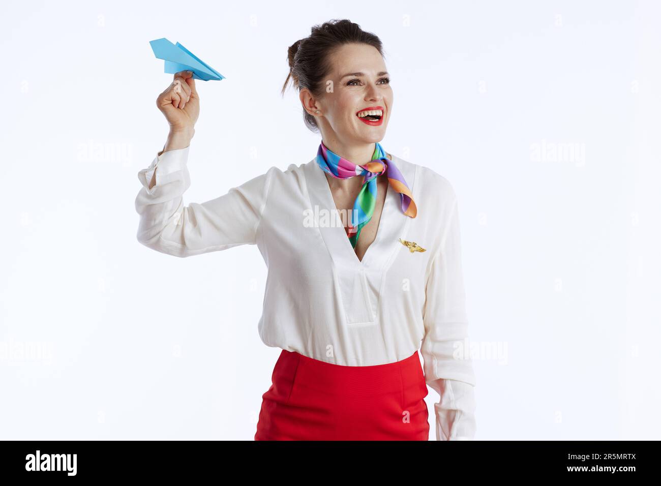 smiling elegant female flight attendant against white background in ...