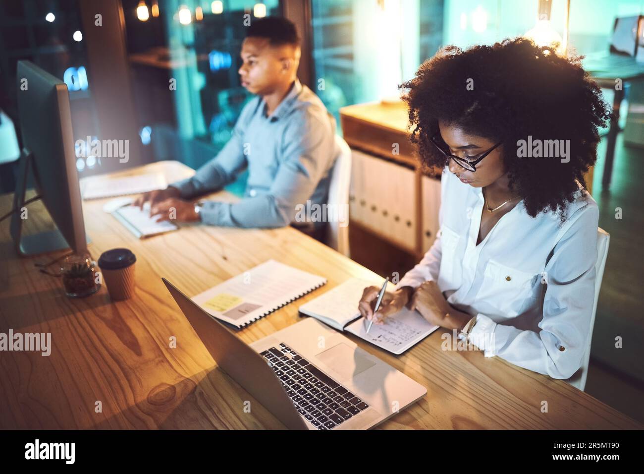Noting down a few tasks that she needs to complete soon. a young ...