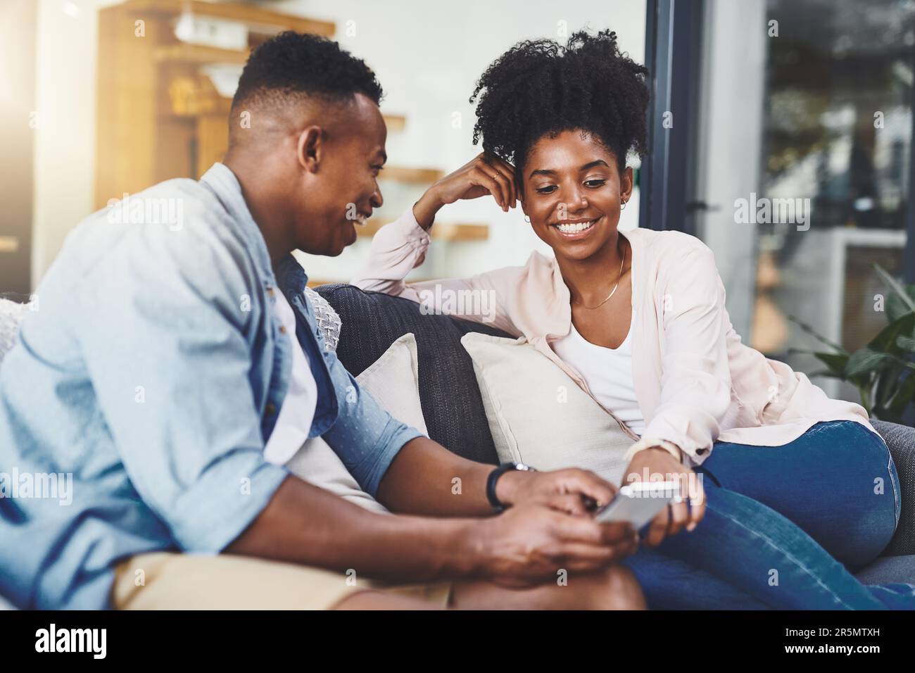 When you share you care. a happy young couple relaxing together on the ...