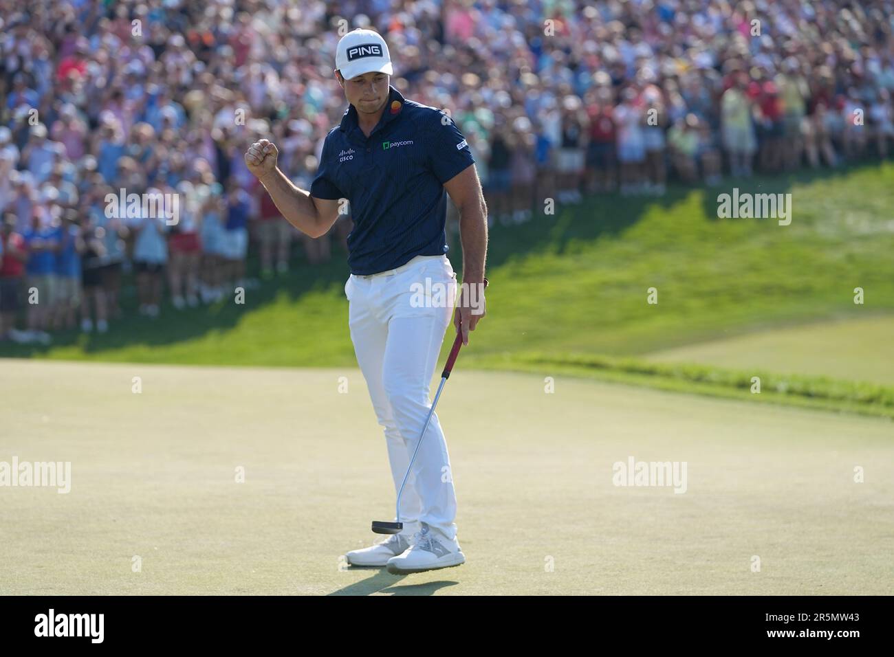 Viktor Hovland, of Norway, reacts after making a putt on the first ...
