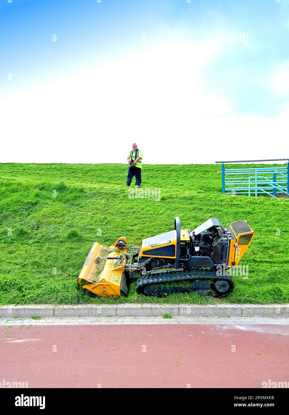 North Tyneside council workert using the radio controlled Robocut grass ...