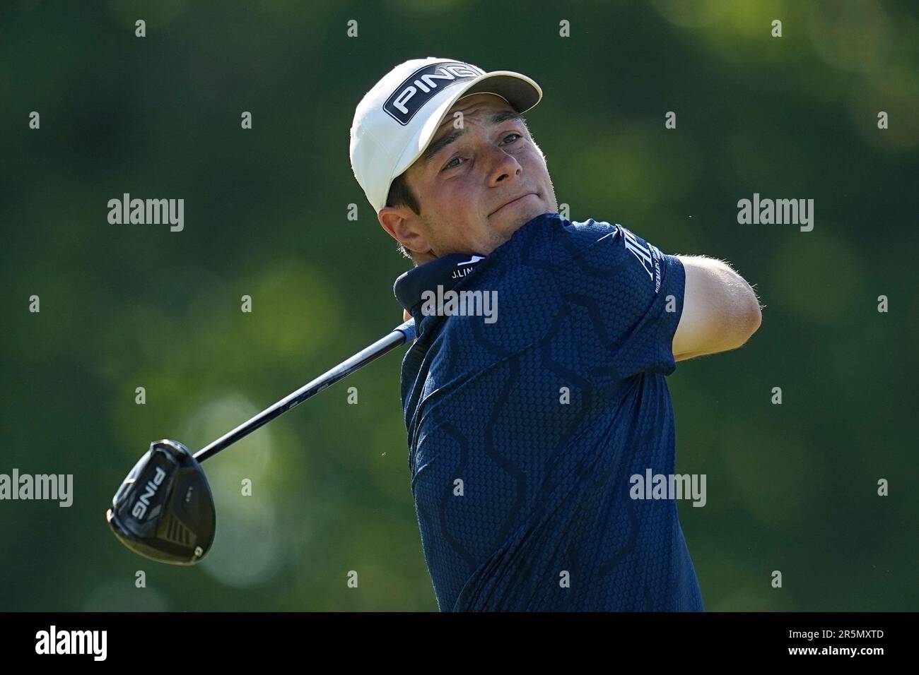 Viktor Hovland, of Norway, tees off on the 18th hole during the final round of the Memorial golf ...