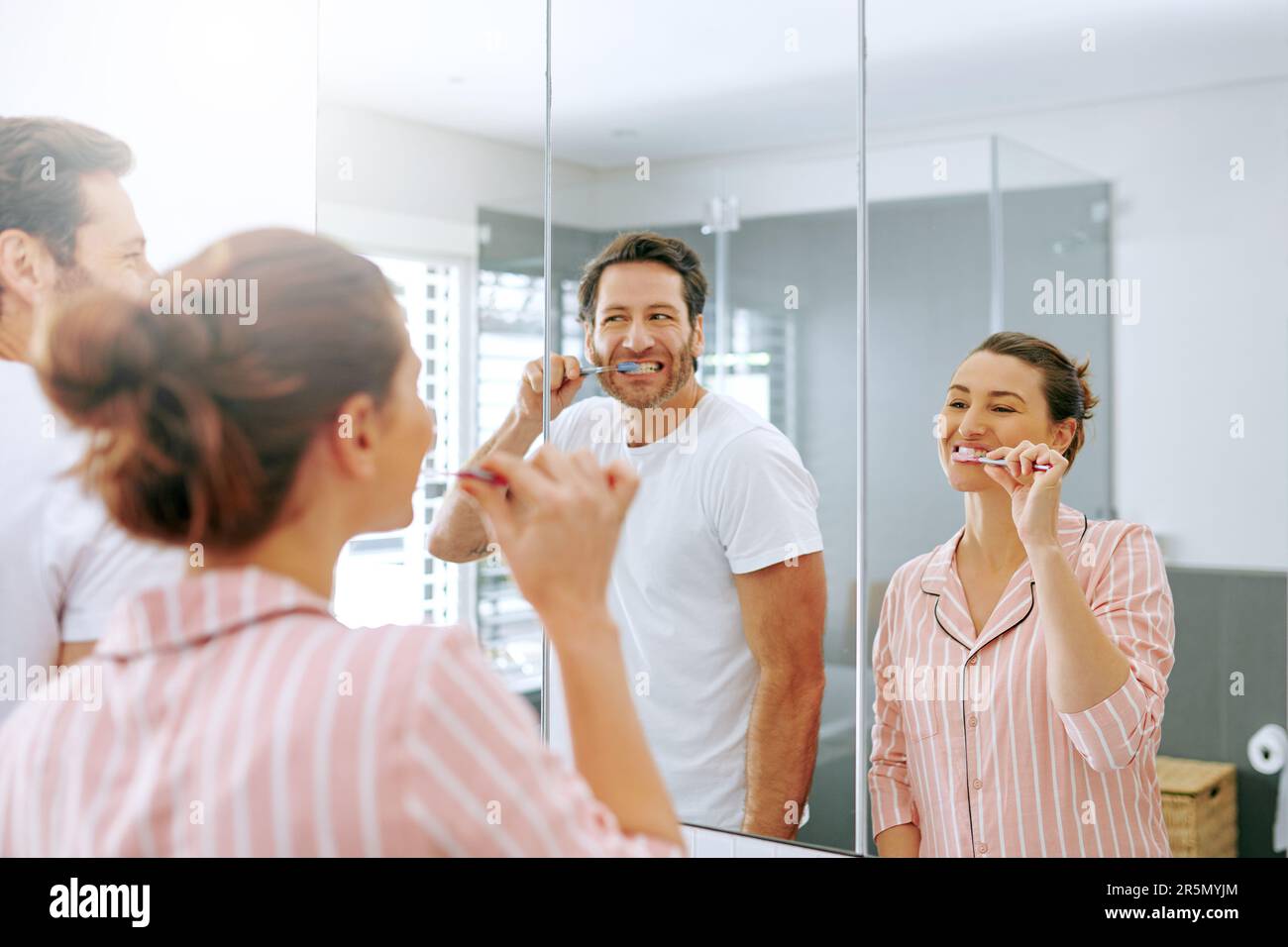 We do everything together. a couple brushing their teeth in the ...