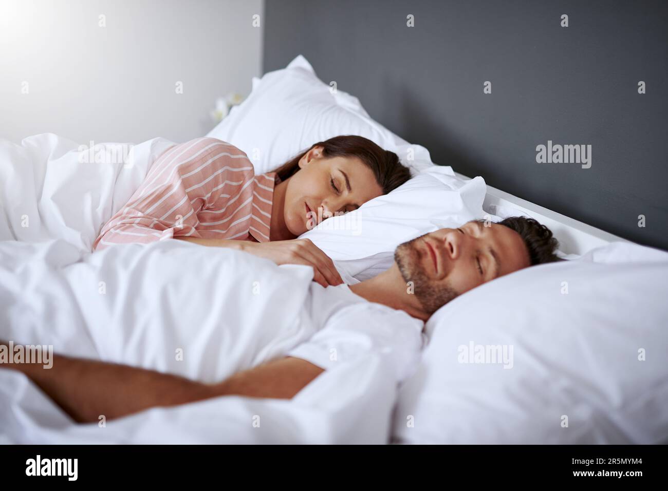 Getting a good nights rest. a middle-aged couple sleeping in bed ...
