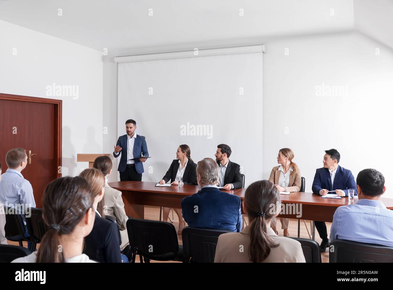 Business conference. People in meeting room listening to speaker report ...