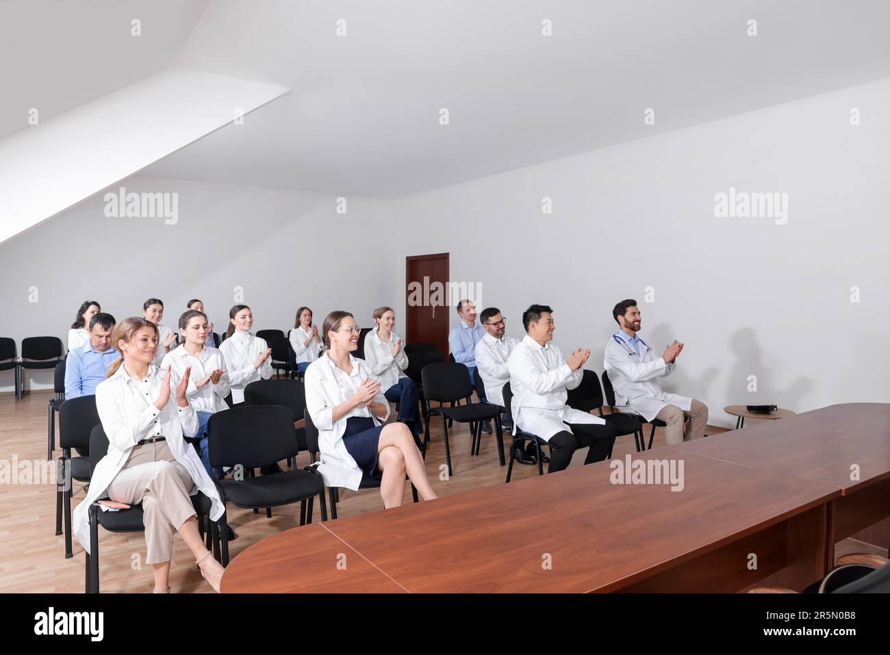 Team of doctors in meeting room during medical conference Stock Photo ...