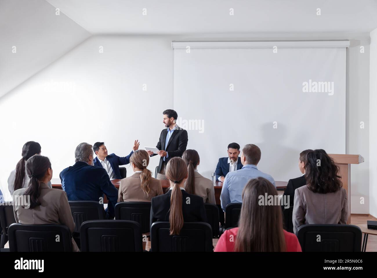 Business conference. People in meeting room listening to speaker report ...
