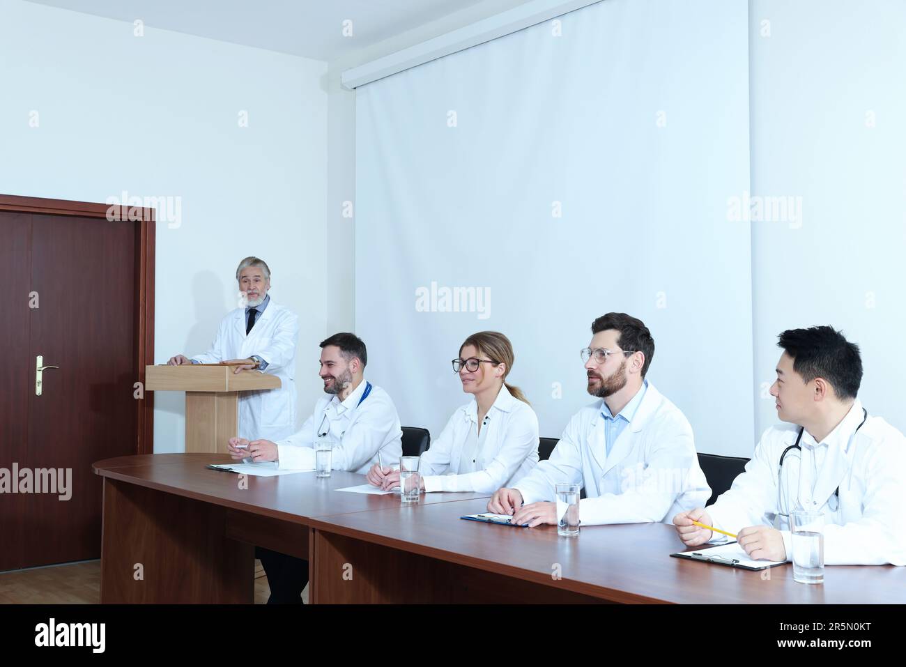 Female doctor giving presentation in hi-res stock photography and ...