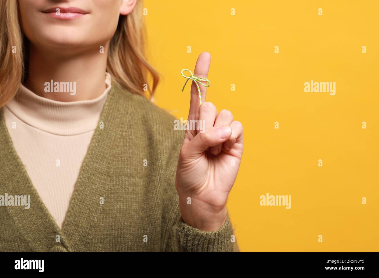 Woman index finger remember hi-res stock photography and images - Alamy