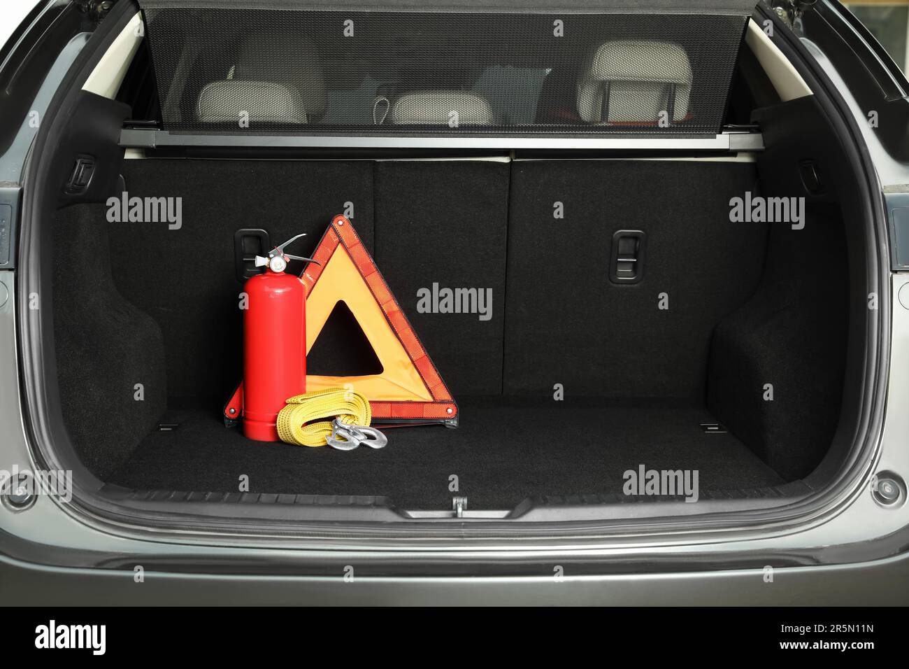 Red fire extinguisher, towing strap and foldable emergency warning ...