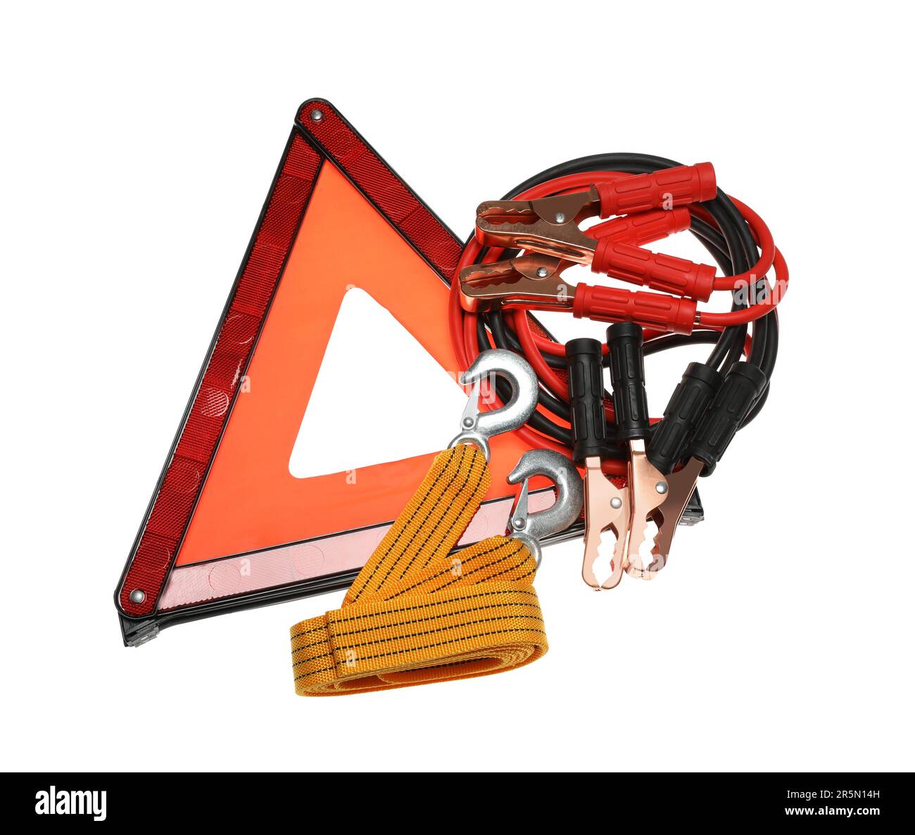 Emergency warning triangle, towing strap and battery jumper cables on ...