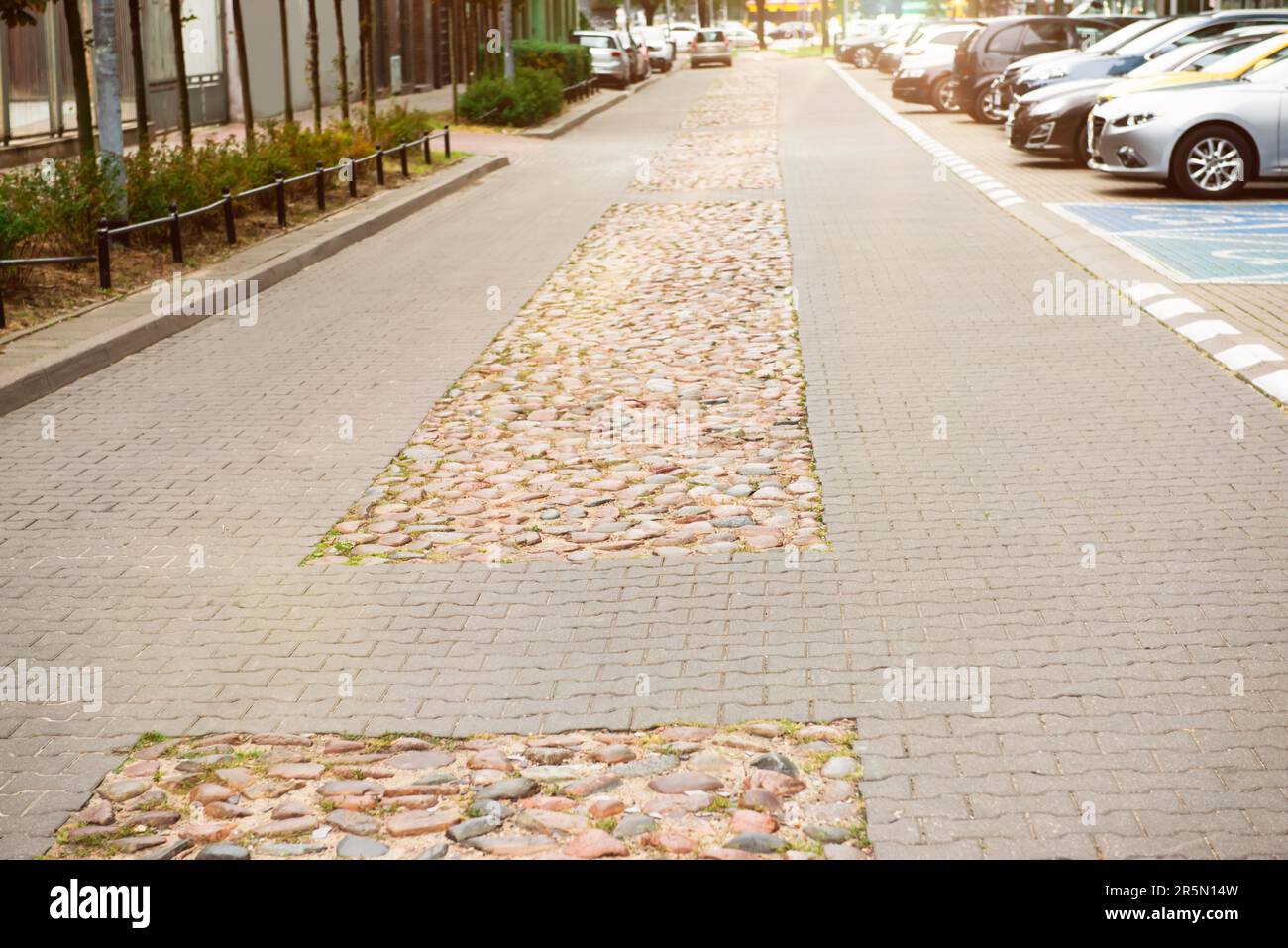 Sidewalk path near cars on city street. Footpath covering Stock Photo ...