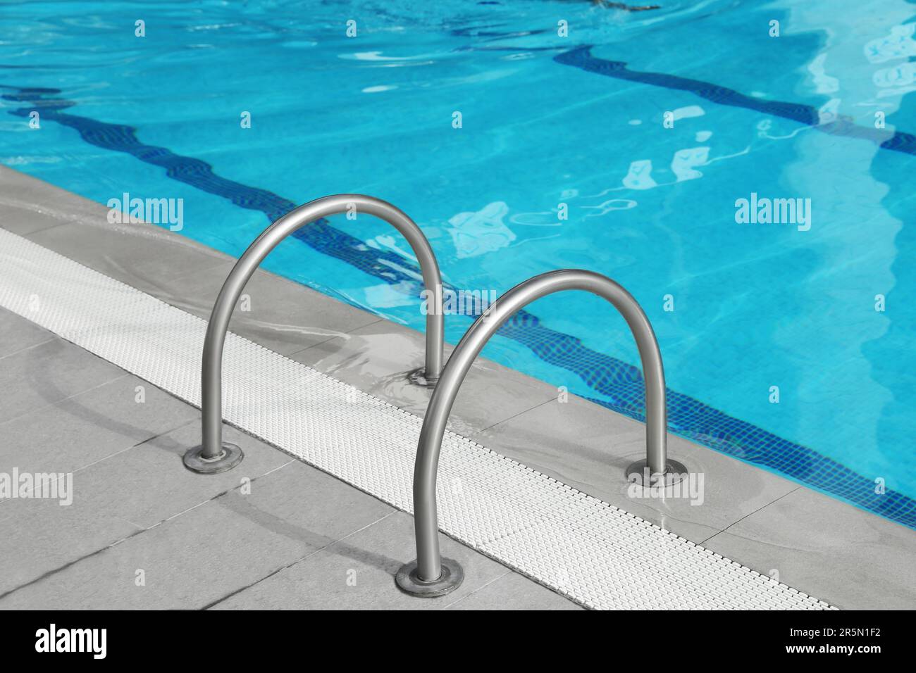 Ladder with handrails in outdoor swimming pool Stock Photo - Alamy