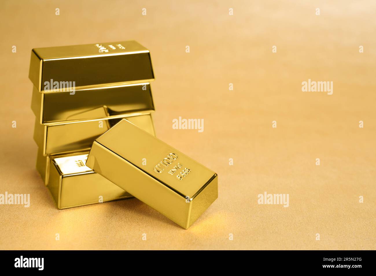 Many shiny gold bars on color background. Space for text Stock Photo - Alamy