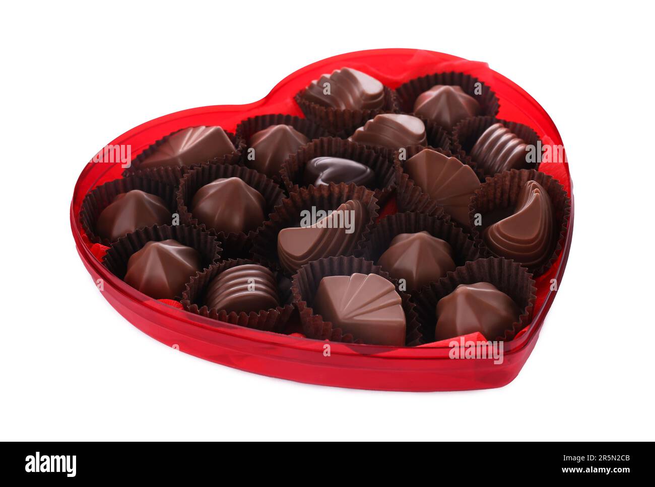 Heart shaped box with delicious chocolate candies on white background ...