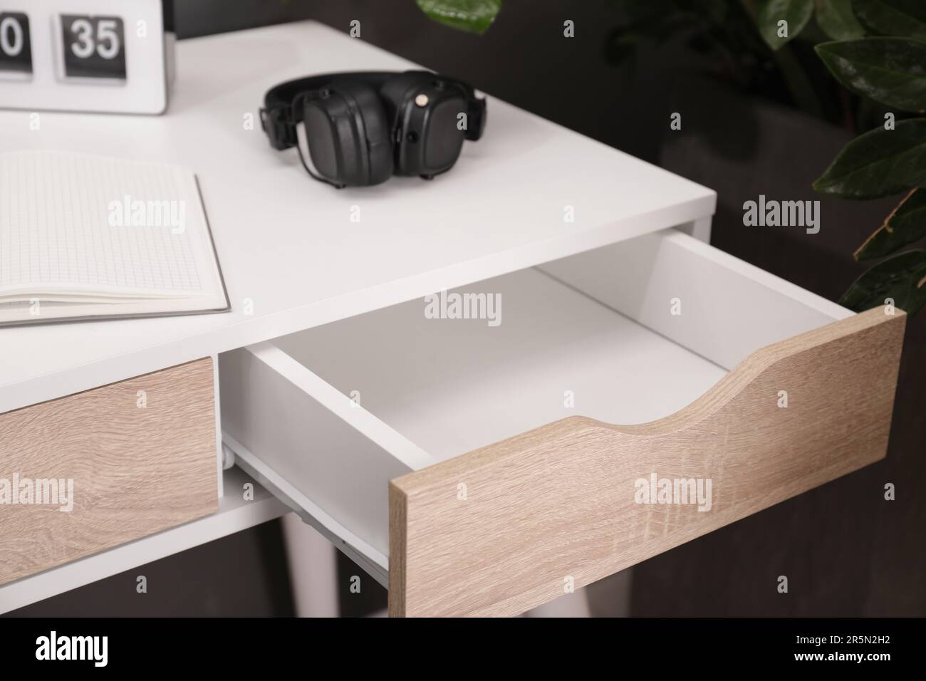 Stylish desk with open empty drawer in office Stock Photo - Alamy