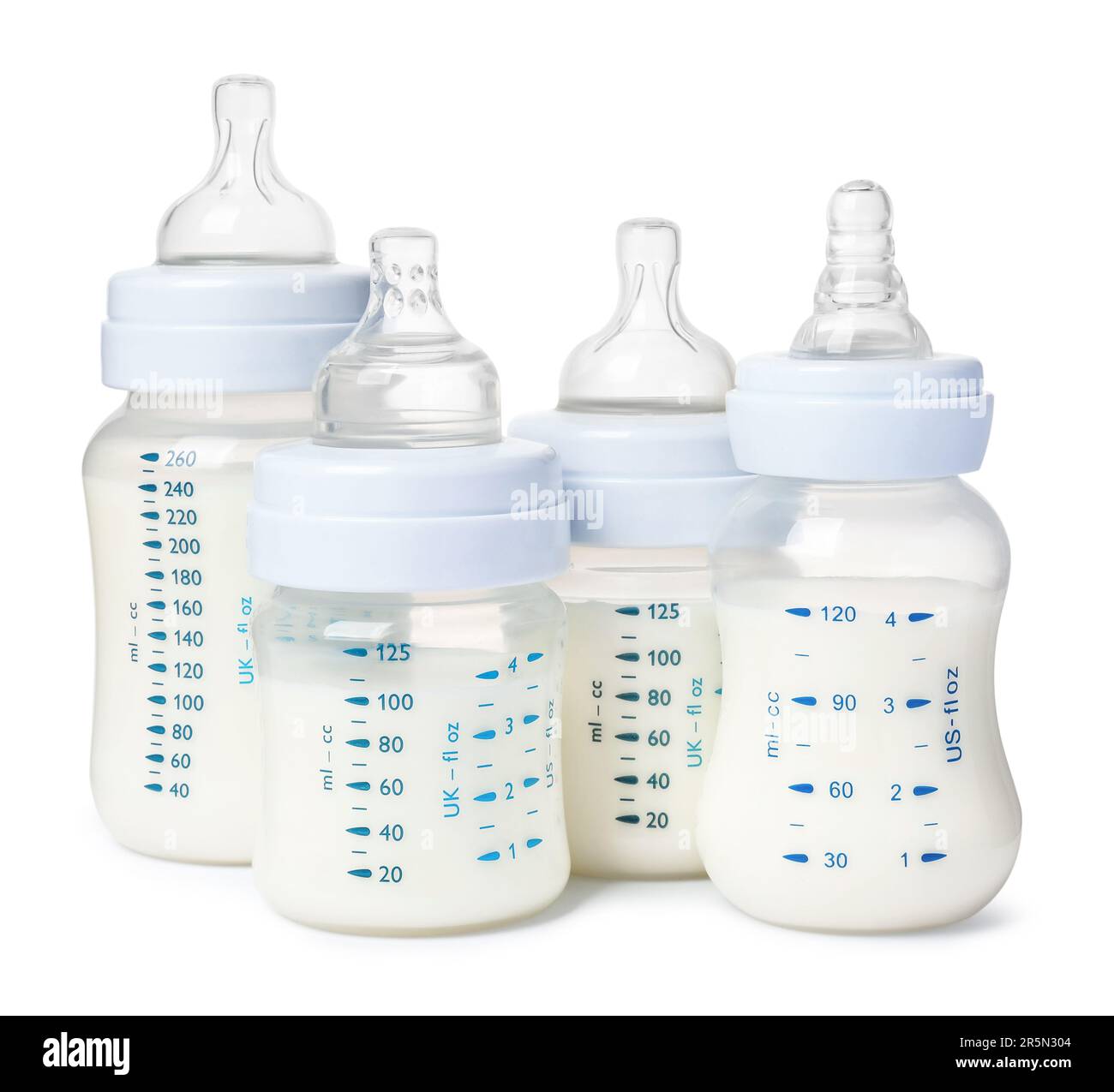 Many feeding bottles with infant formula on white background Stock ...