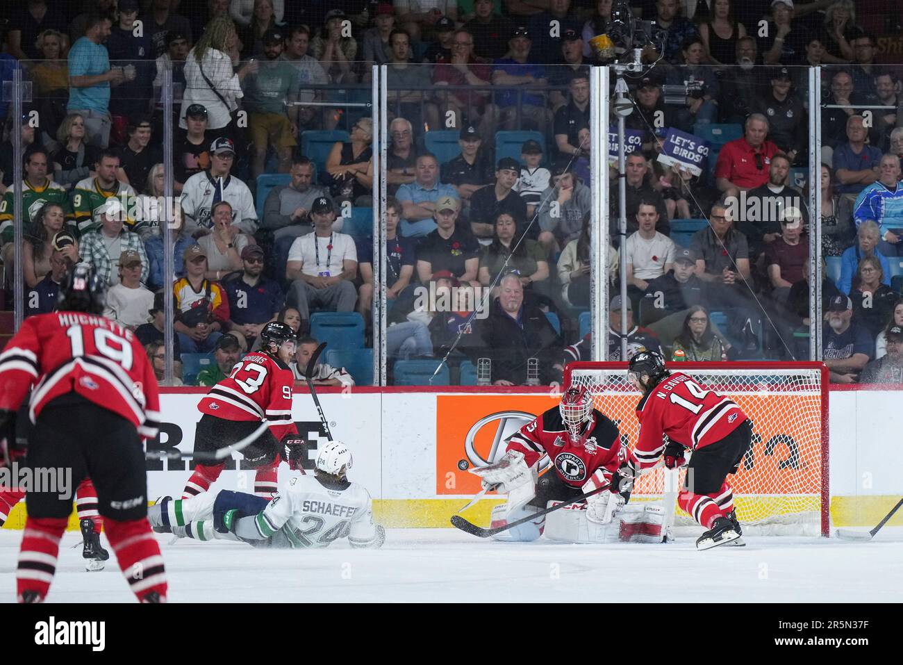 Quebec Remparts goalie William Rousseau, second right, stops Seattle ...