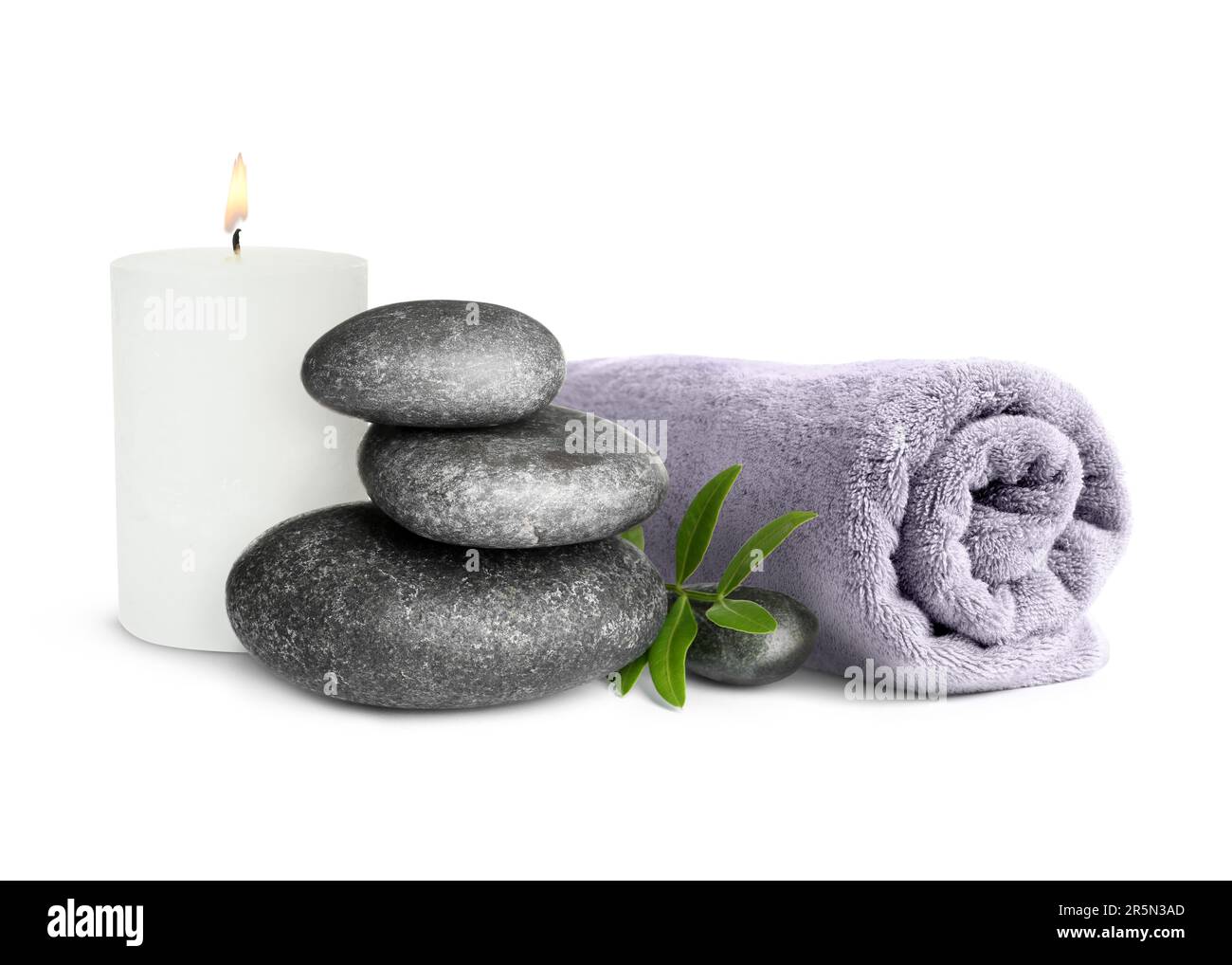 Beautiful composition with burning candle, stacked stones and rolled ...