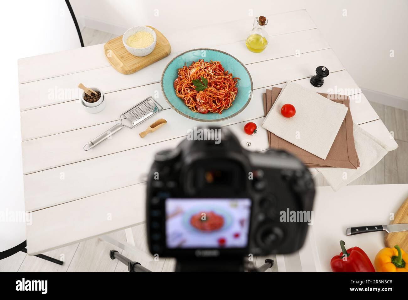 Professional camera and composition with spaghetti on table in studio ...