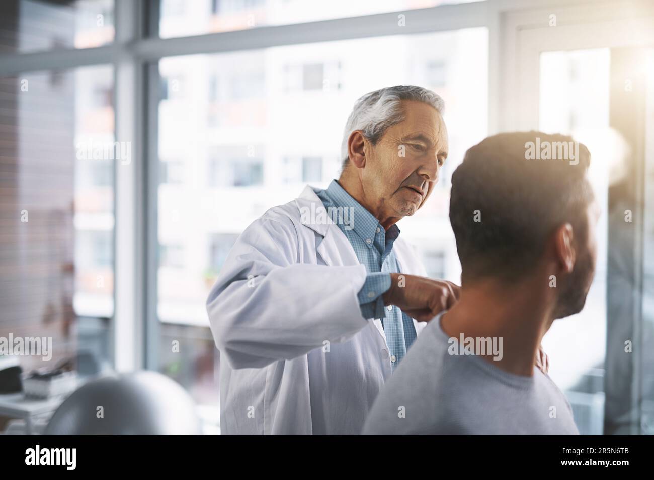 Hows this shoulder coming along. a senior doctor giving his male ...