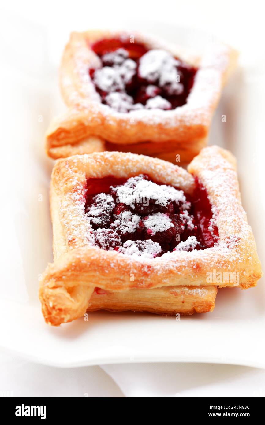 Delicious Cherry puff pastry with powdered sugar Stock Photo - Alamy