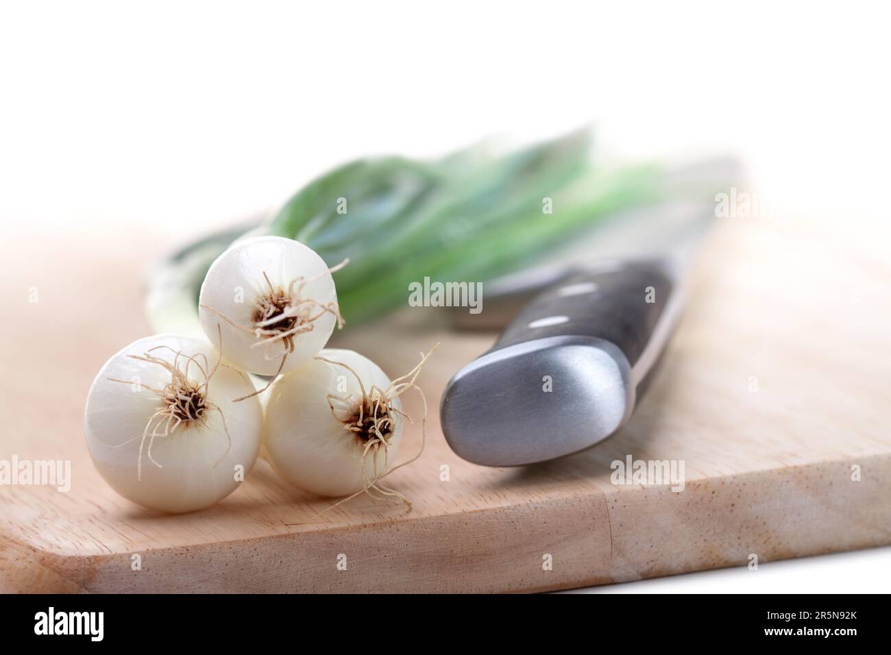 Three bulbs spring onions on white background Stock Photo - Alamy