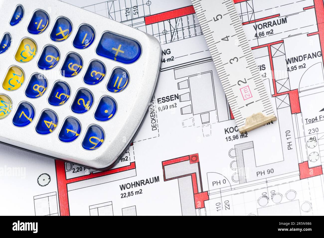 Calculator and ruler on a house plan for calculating Stock Photo - Alamy