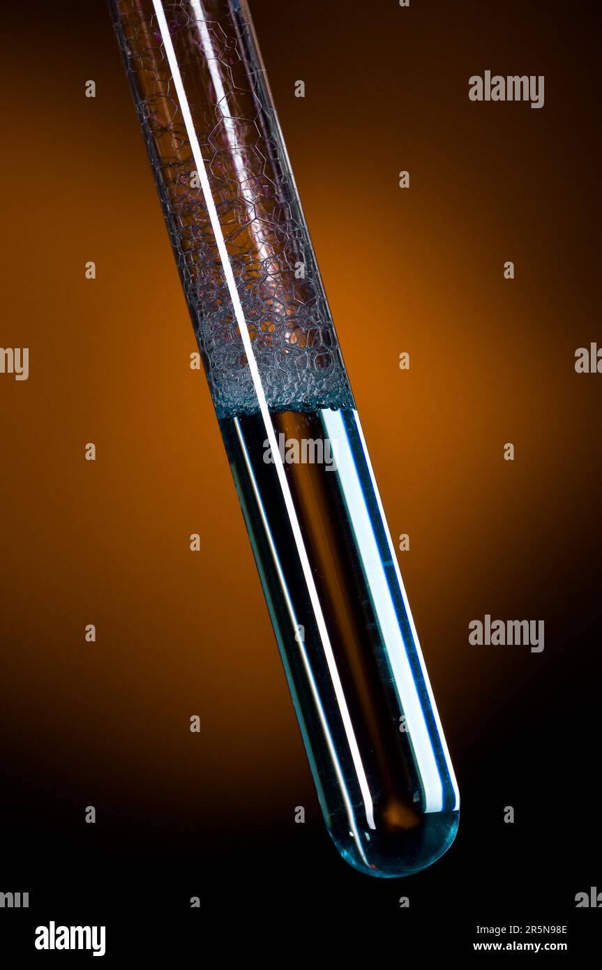 Glass test tube filled with liquid and foam Stock Photo - Alamy
