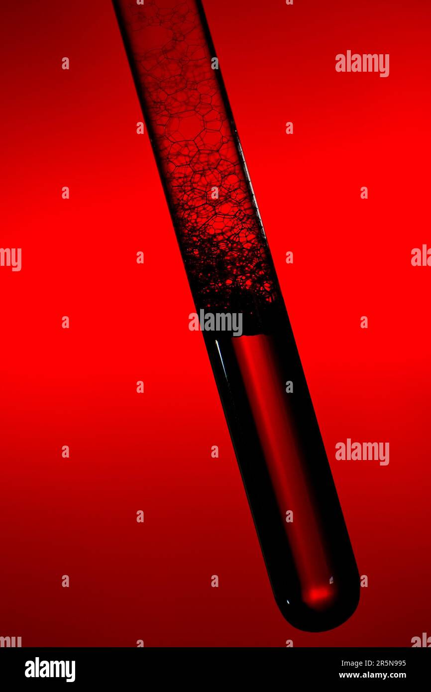 Glass test tube filled with liquid and foam Stock Photo - Alamy
