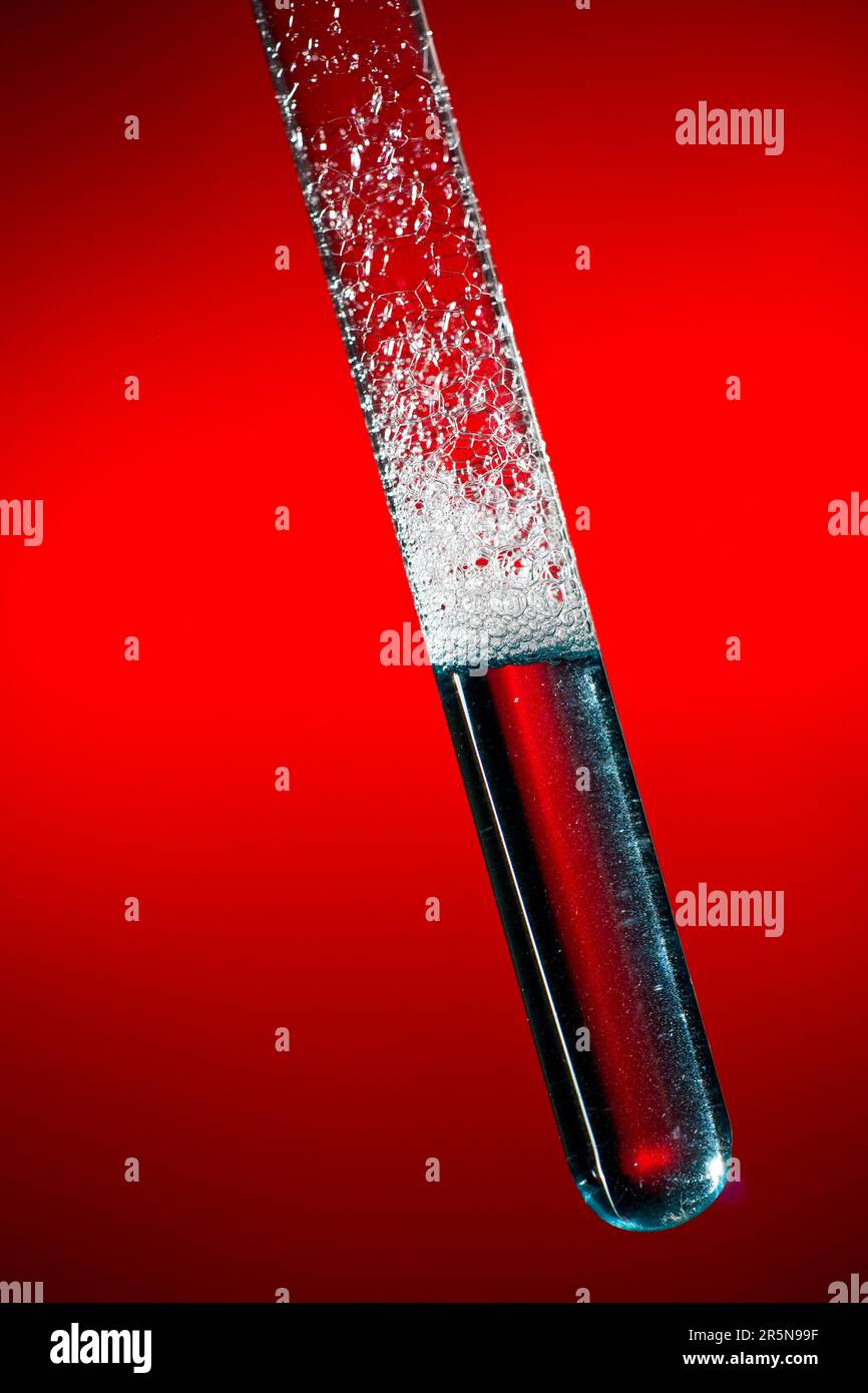 Glass test tube filled with liquid and foam Stock Photo - Alamy