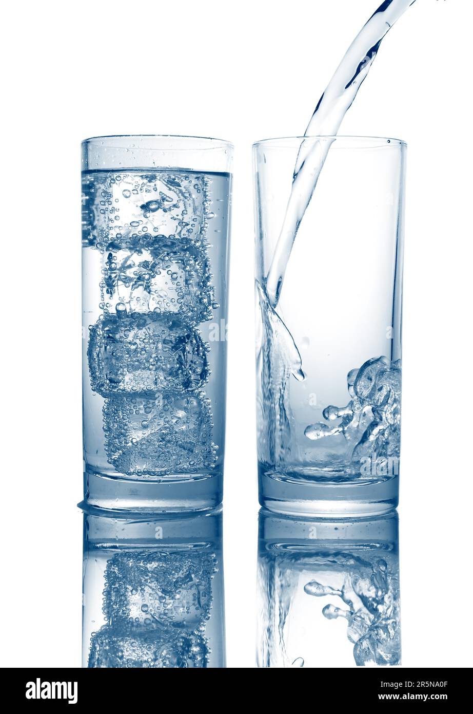 Pouring of fresh cool water in a glass isolated on white background ...