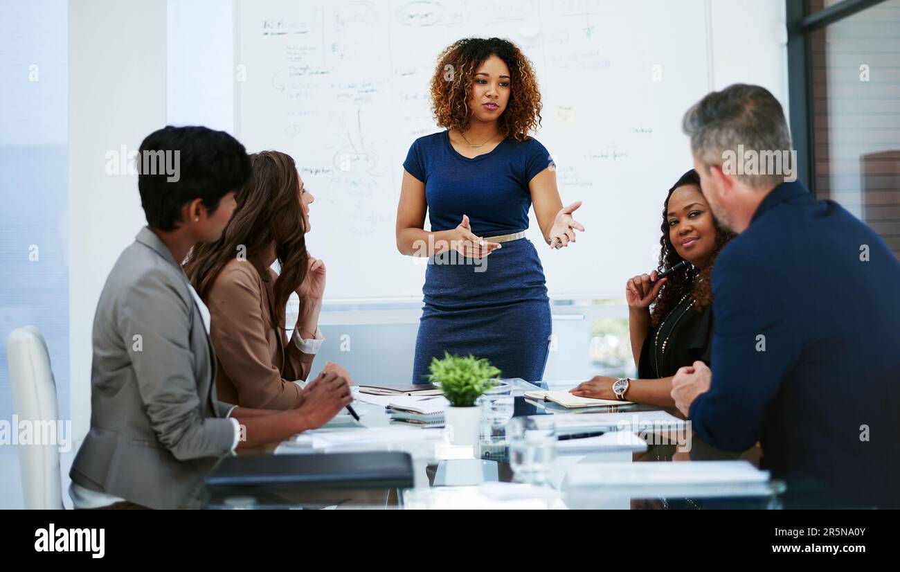 Explaining her plan in detail. a young businesswoman giving a ...