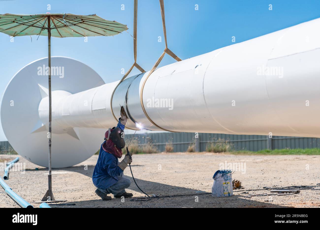 Technician welding pipe of water tower in factory Stock Photo - Alamy