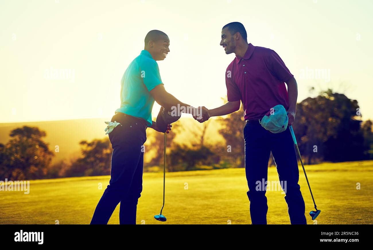 May the course be with you. two golfers shaking hands on the golf ...