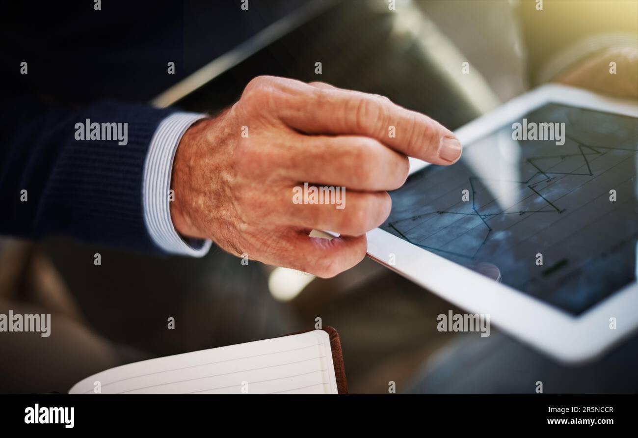 How the smart entrepreneur works. a businessman using a digital tablet ...