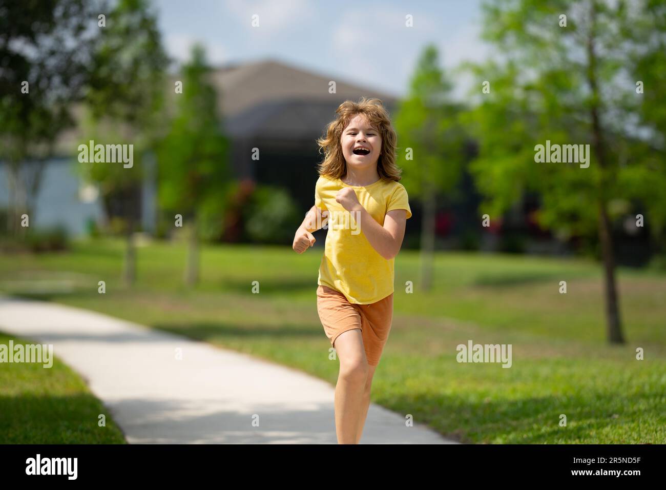 Excited Kid running in street. Amazed child enjoy run. Happy little boy ...