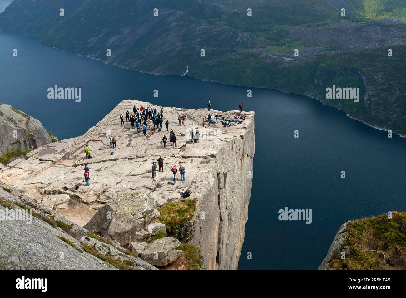 Tourists on rock platform Preikestolen, Ryfylke, Rogaland Province ...