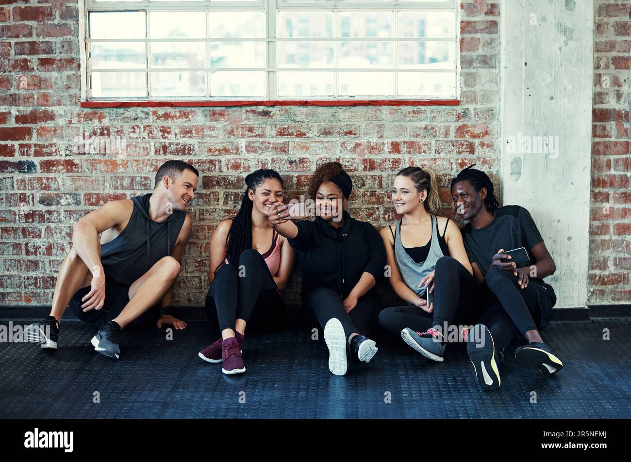 Try not to pose. a cheerful young group of people sitting down on the ...