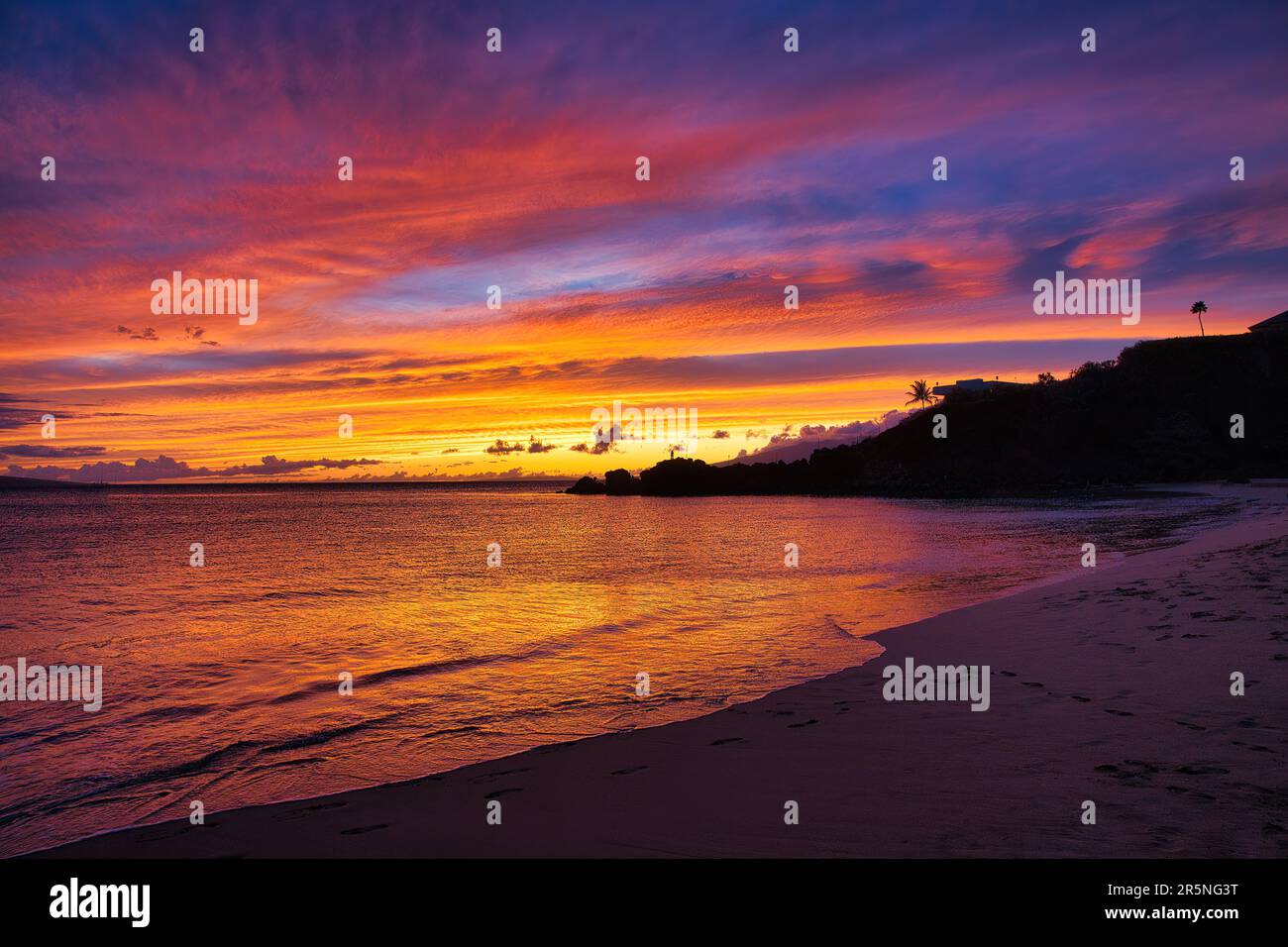 Stunning pink, blue, and gold sunset at Black Rock on Maui Stock Photo ...