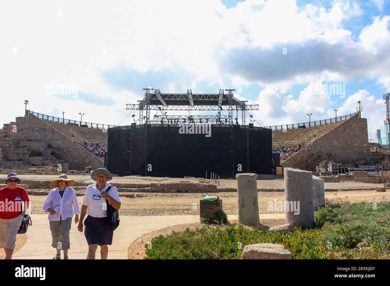 Tourist walk from an ancient Roman amphitheater with a modern stage in ...