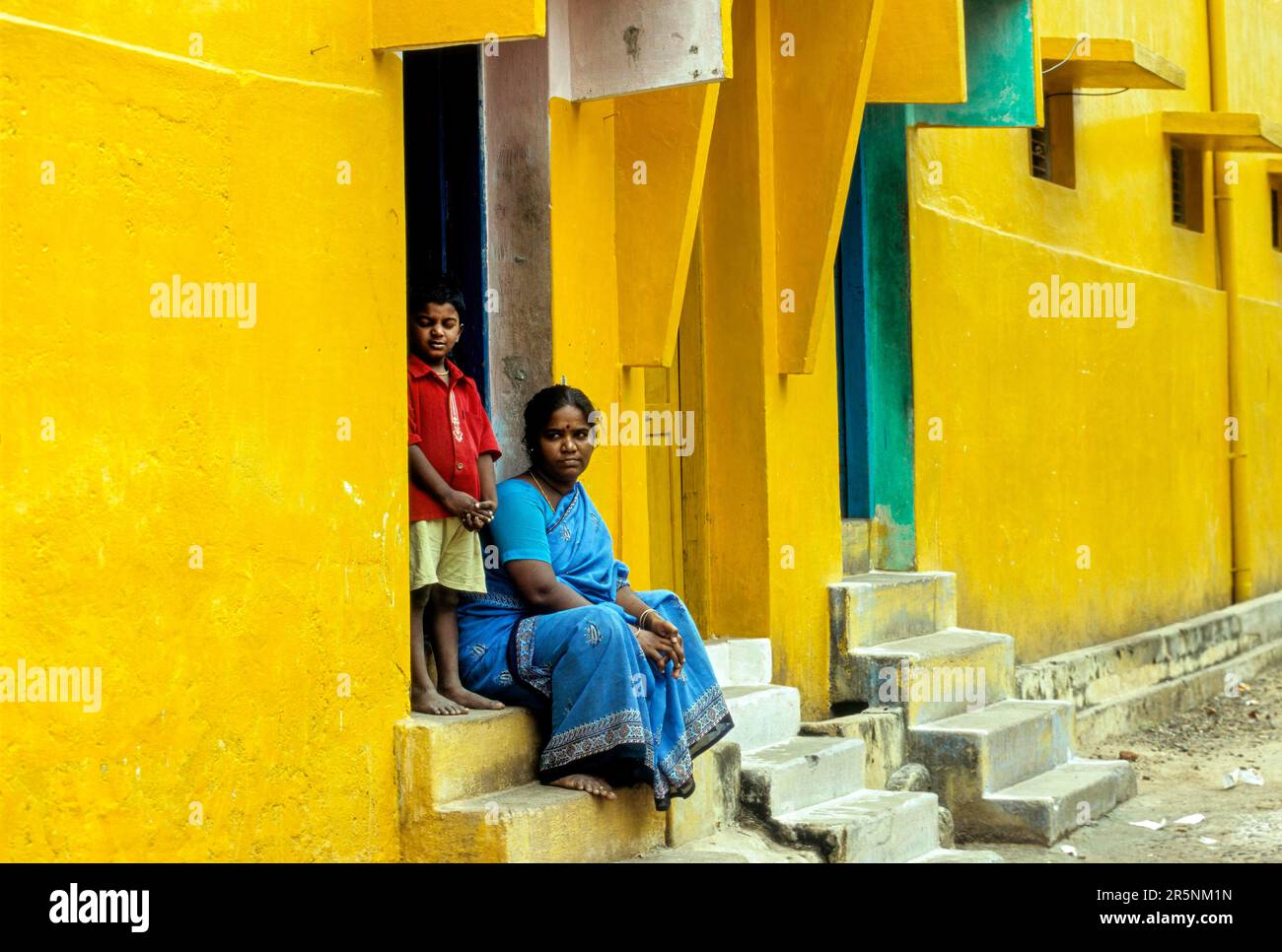 A mother and her son in front of their house at Courtalam Kutralam ...