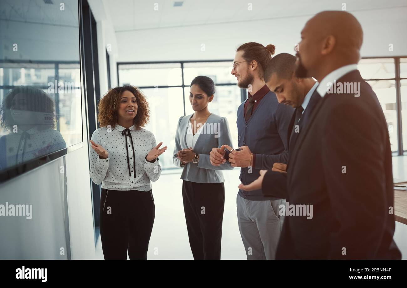 Getting some input from her colleagues. a young businesswoman giving a ...