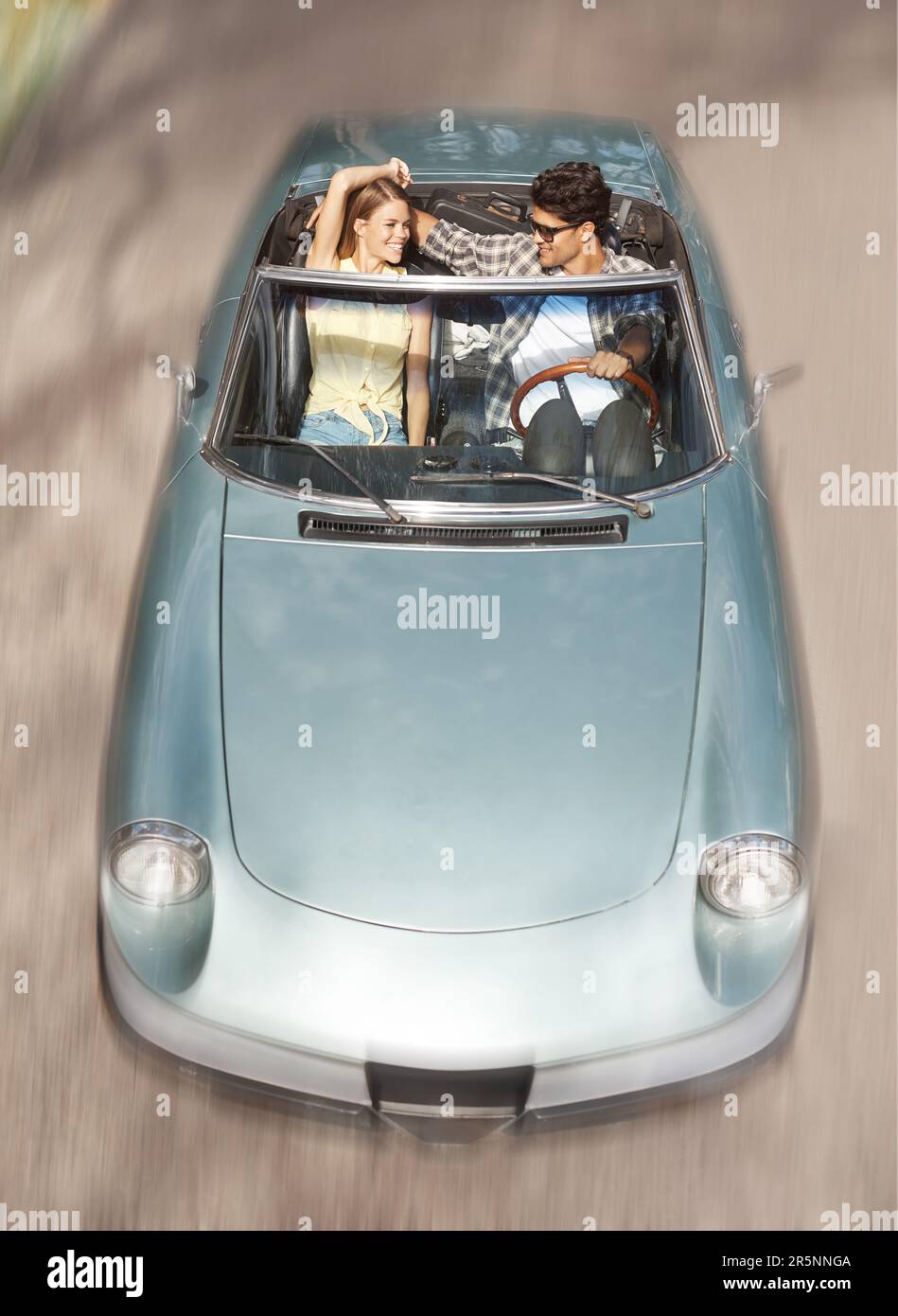 Feeling The Wind Through My Hair Attractive Young Couple Riding Together In An Open Top Sports
